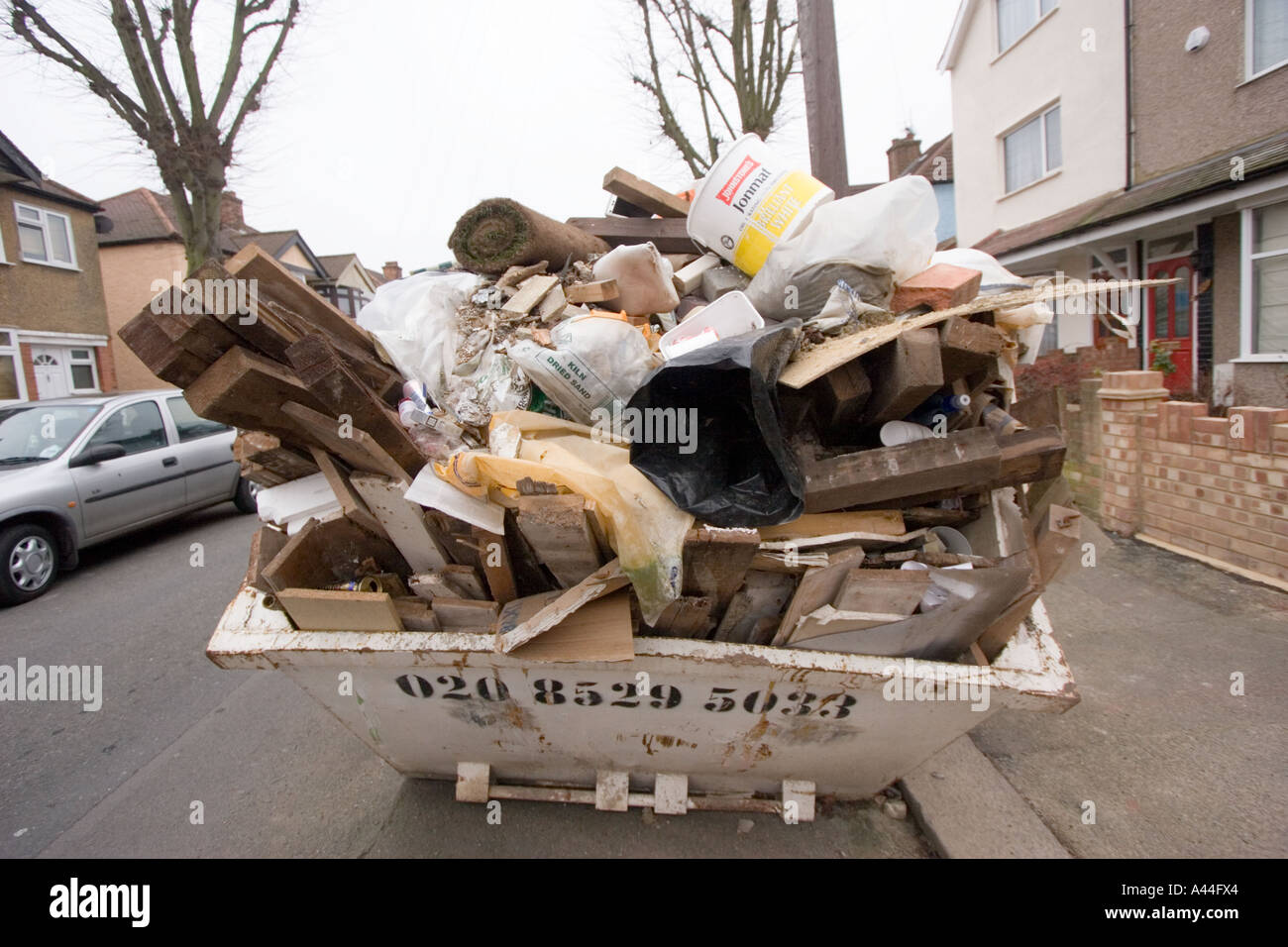 Unlicensed and Overloaded Skip in road, full of DIY rubbish outside ...