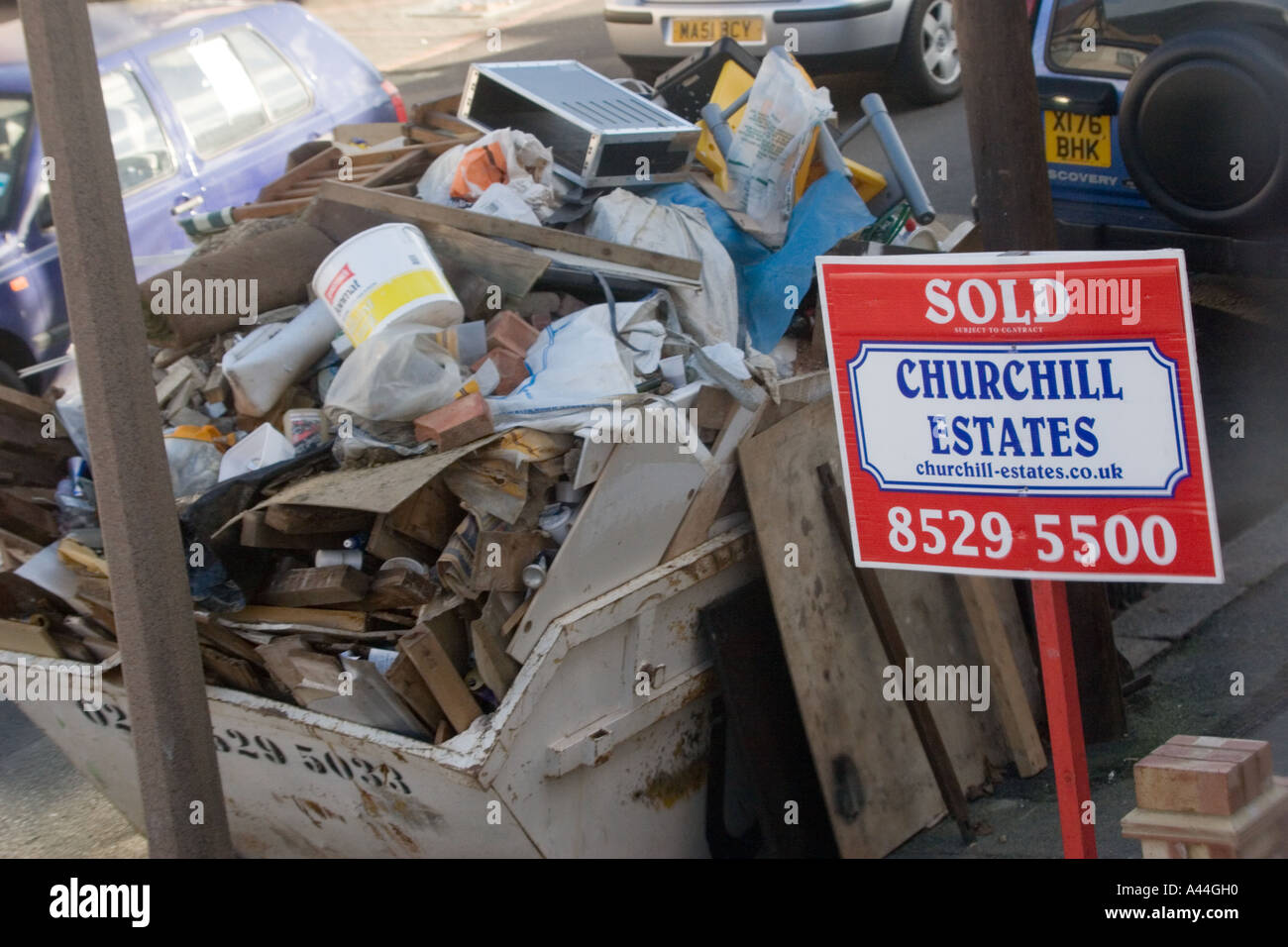 Unlicensed and Overloaded Skip in road, full of DIY rubbish outside ...