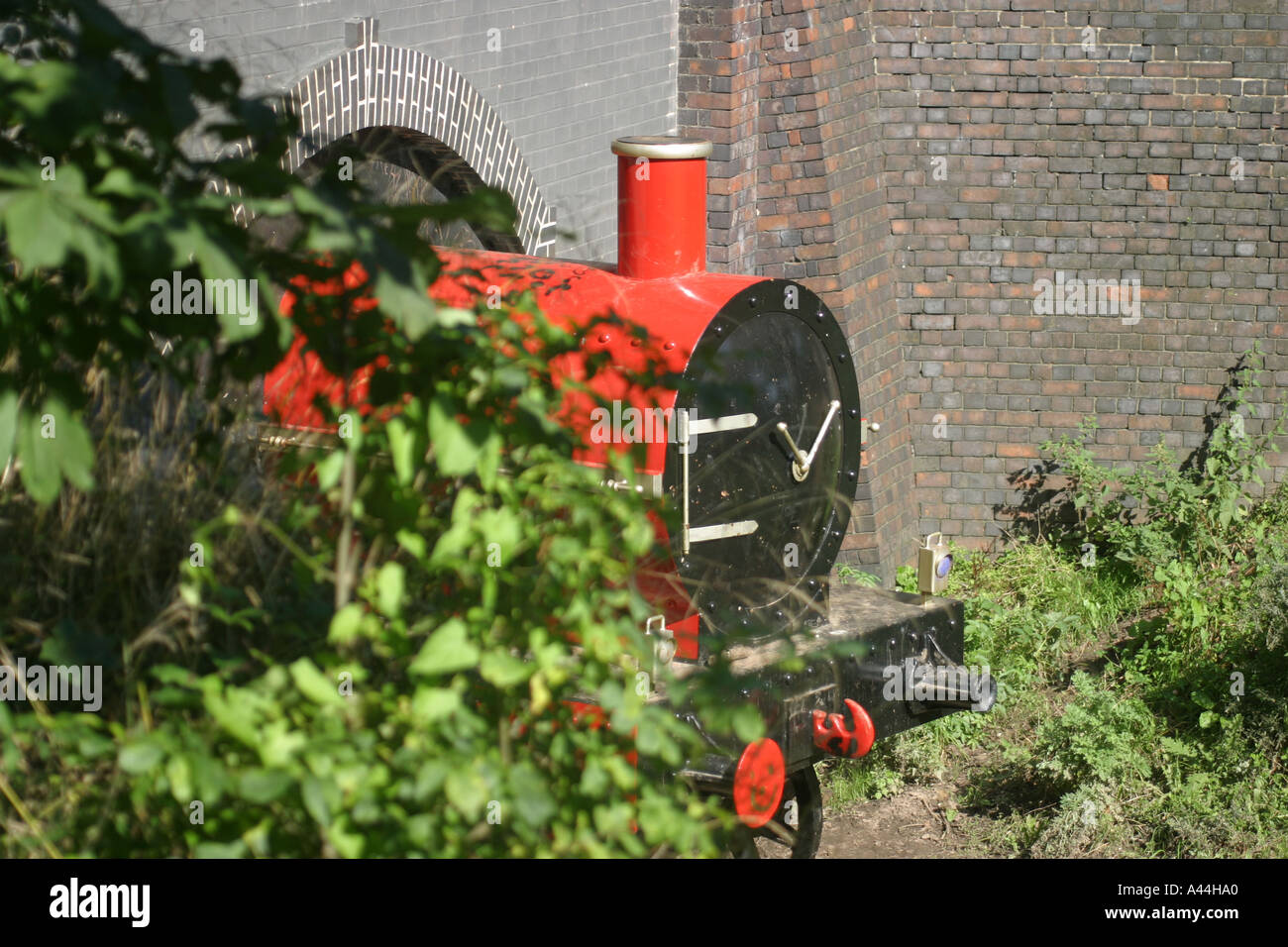 A train coming out of a tunnel The shell of an old steam train has been ...