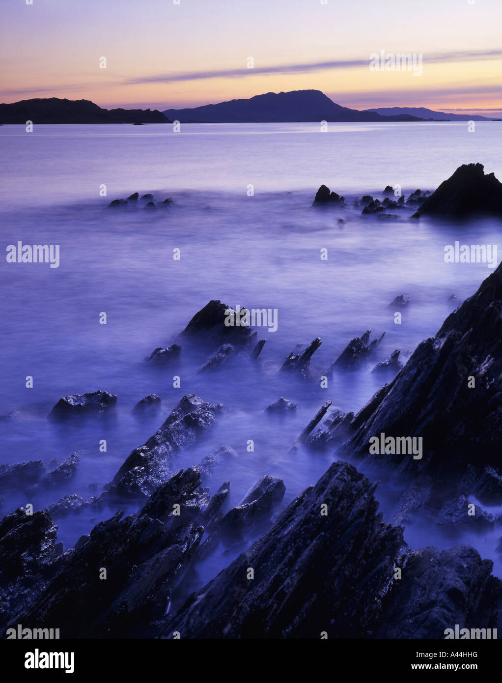 Slate fins projecting through the surf, Isle of Seil, Argyll Stock ...