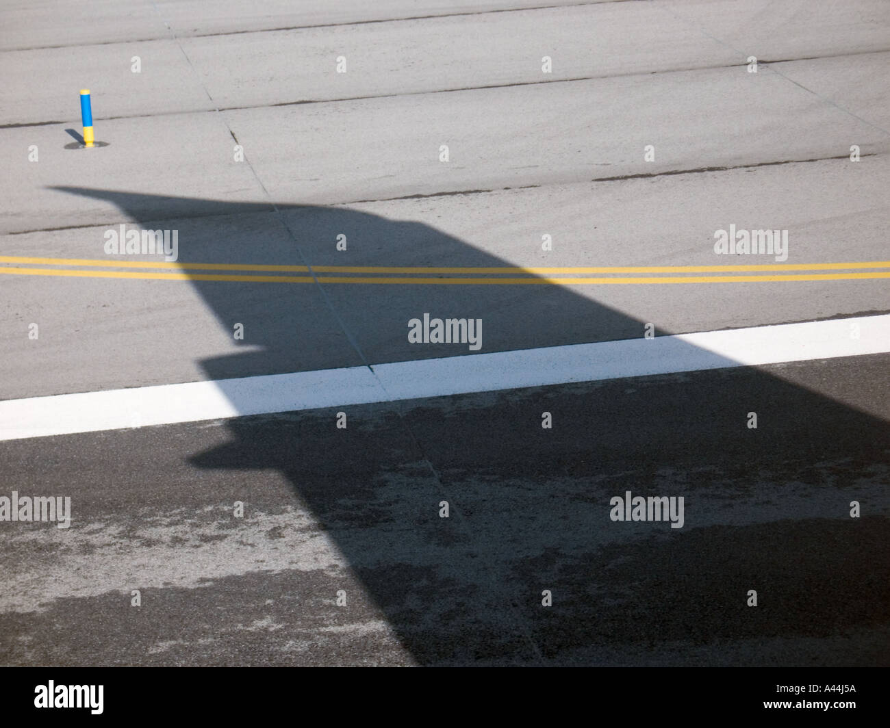 Shadow of plane tail on runway Stock Photo - Alamy