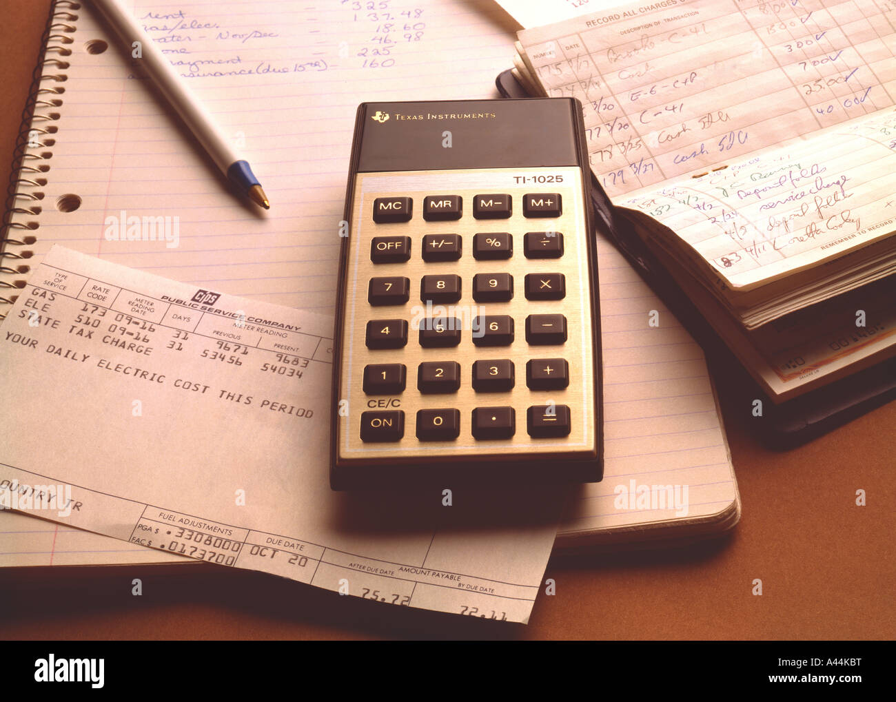 Calculator, utility bills and checkbook registry Stock Photo - Alamy