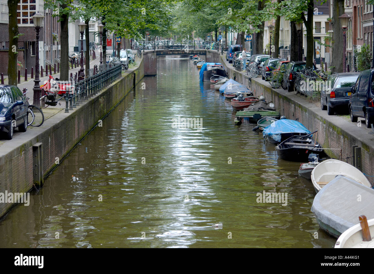 Narrow canal viewed from a bridge, looking down towards the next bridge ...