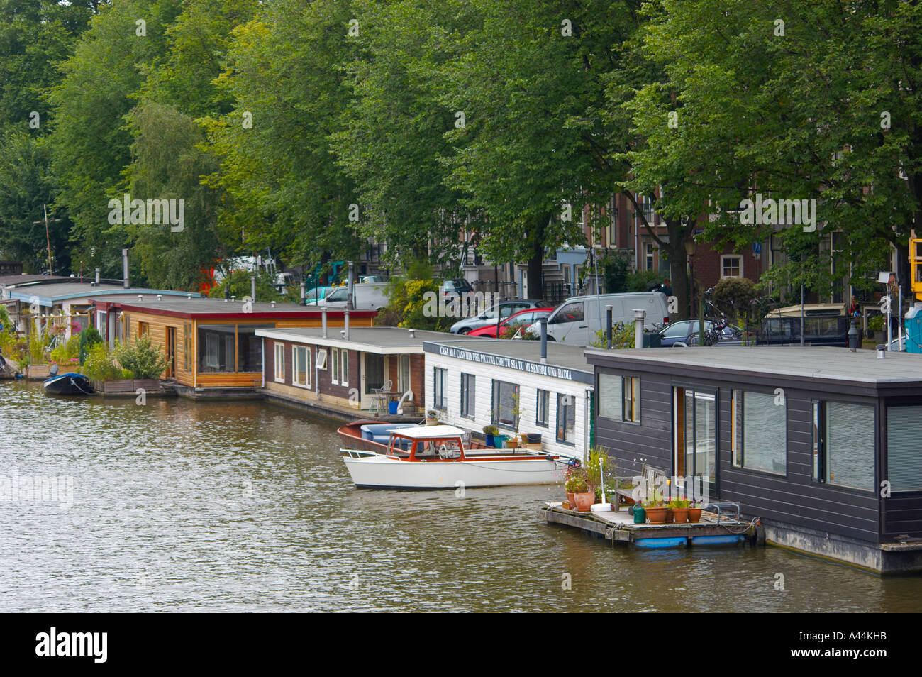 Floating houses moored on the river Amstel. Amsterdam. Netherlands ...