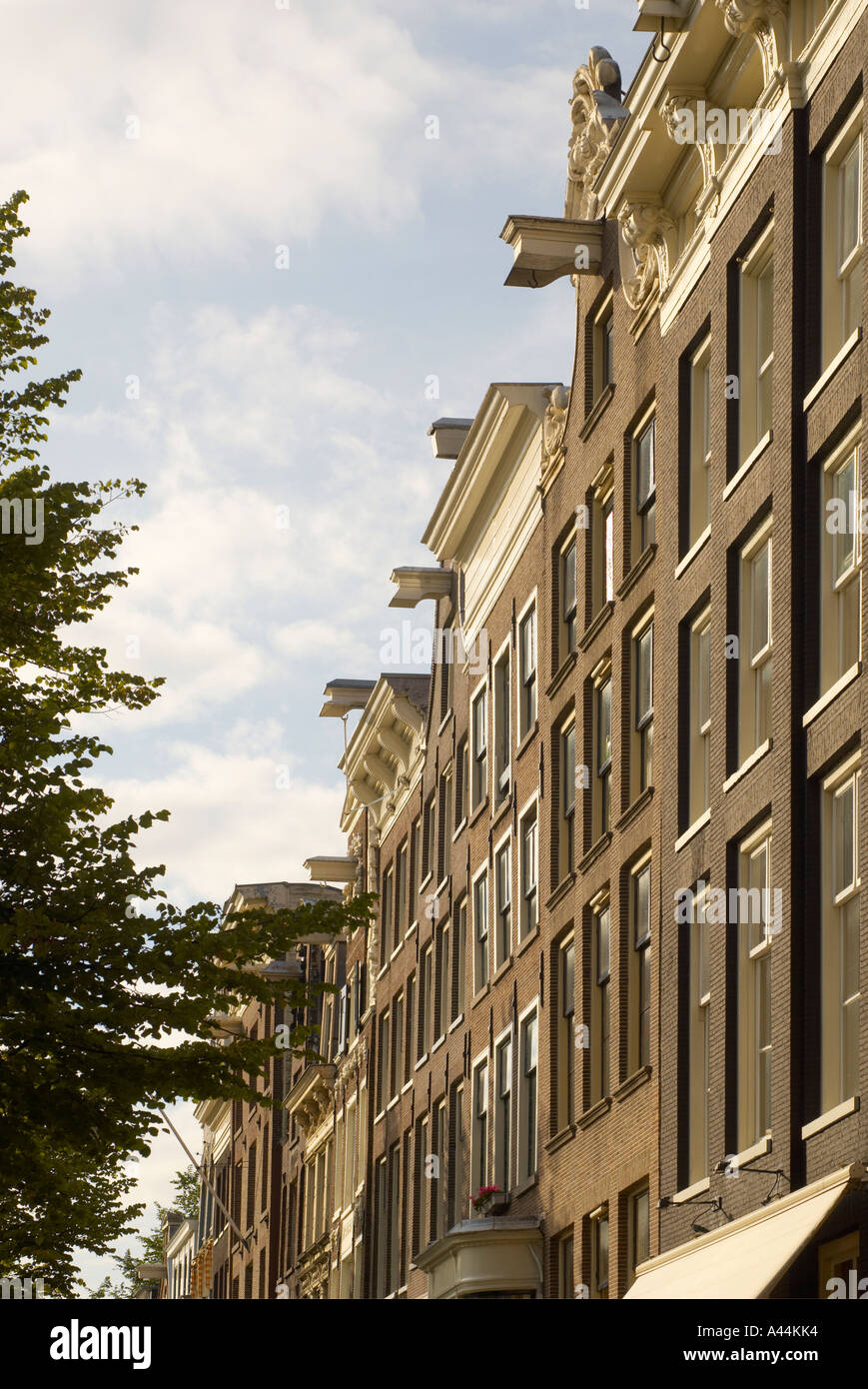 A row of traditional canal houses featuring overhanging hoisting beams ...
