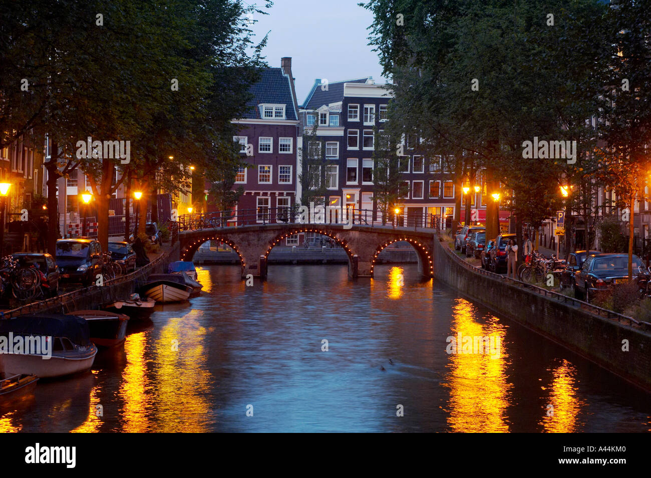 Dusk shot of a traditional arched bridge illuminated with marquee ...