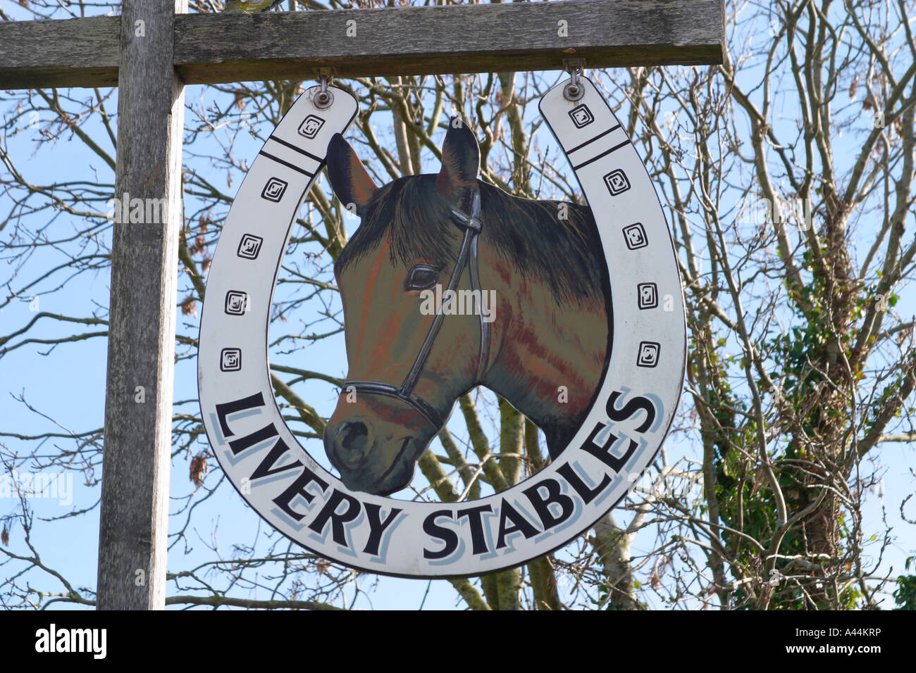 Painted wooden swinging sign advertising livery stables Stock Photo - Alamy