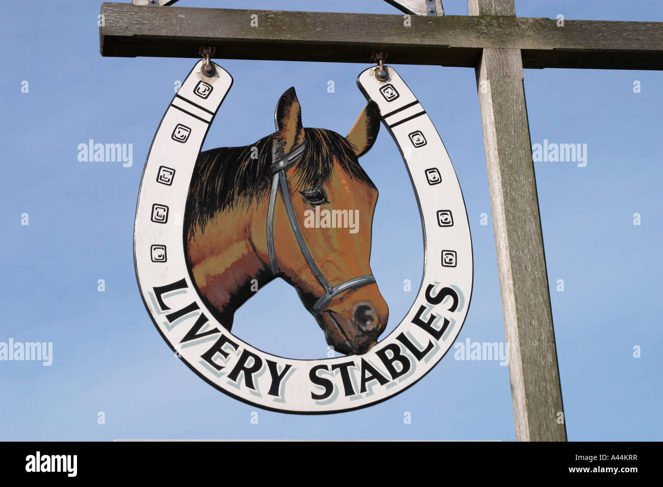 Painted wooden swinging sign advertising livery stables Stock Photo - Alamy