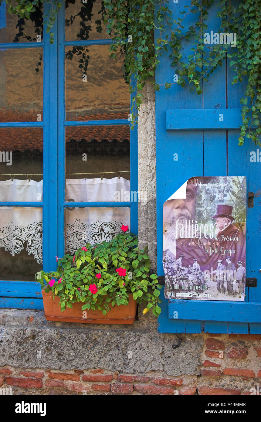 Detail of typical french village window with event poster and blue ...