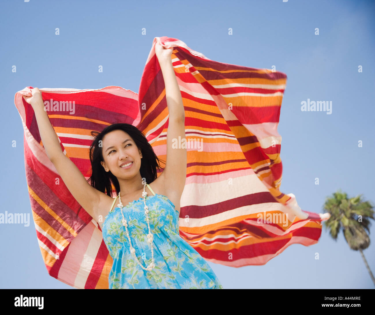 Woman flying sheet over head Stock Photo - Alamy