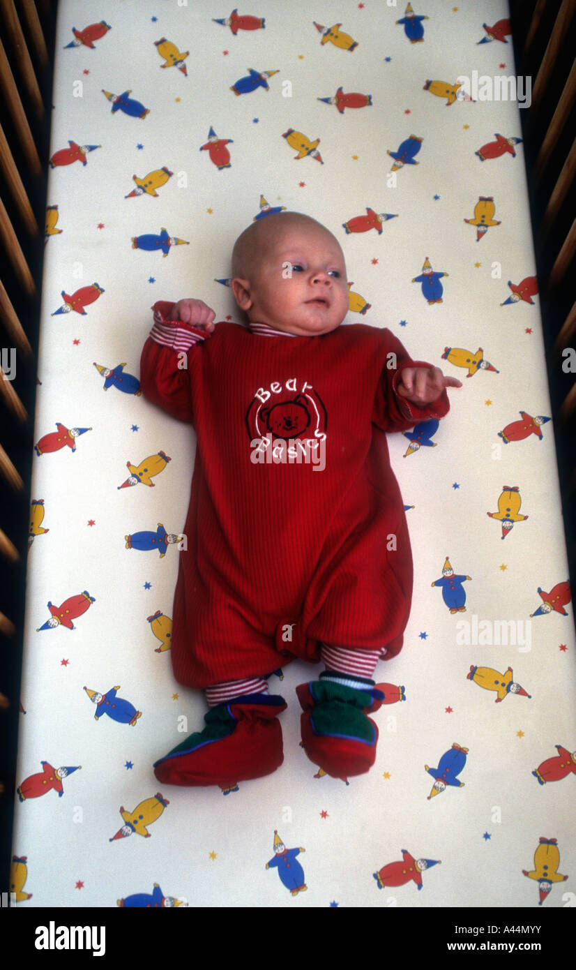 Baby Boy Lying In His Cot Stock Photo - Alamy