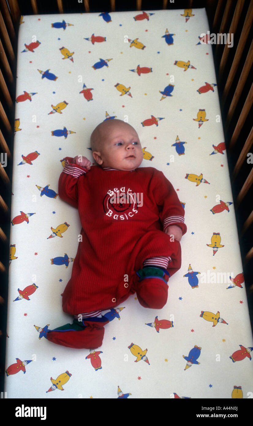 Baby Boy Lying In His Cot Stock Photo - Alamy