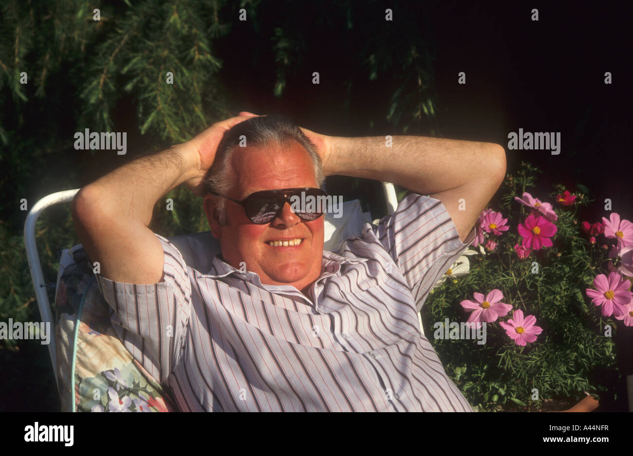 Middle Aged Man, Lying On A Sun Lounger In His Garden,Enjoying The ...