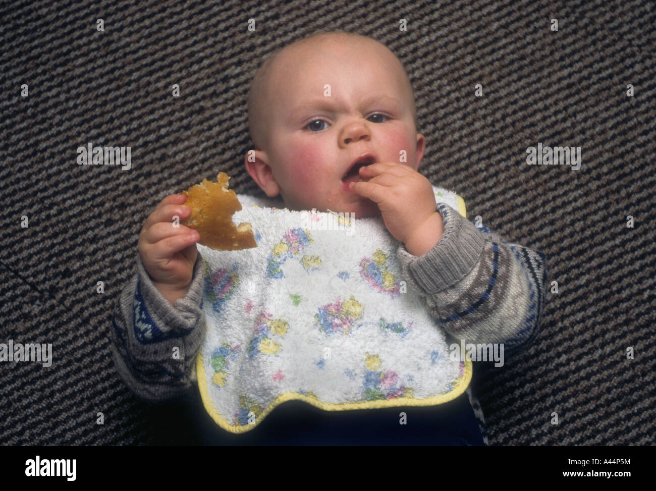 Little Boy Lying On His Back,Eating Part Of A Bread Roll Stock Photo ...