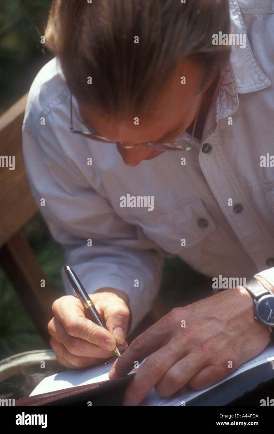 Man Writing a Check Stock Photo - Alamy