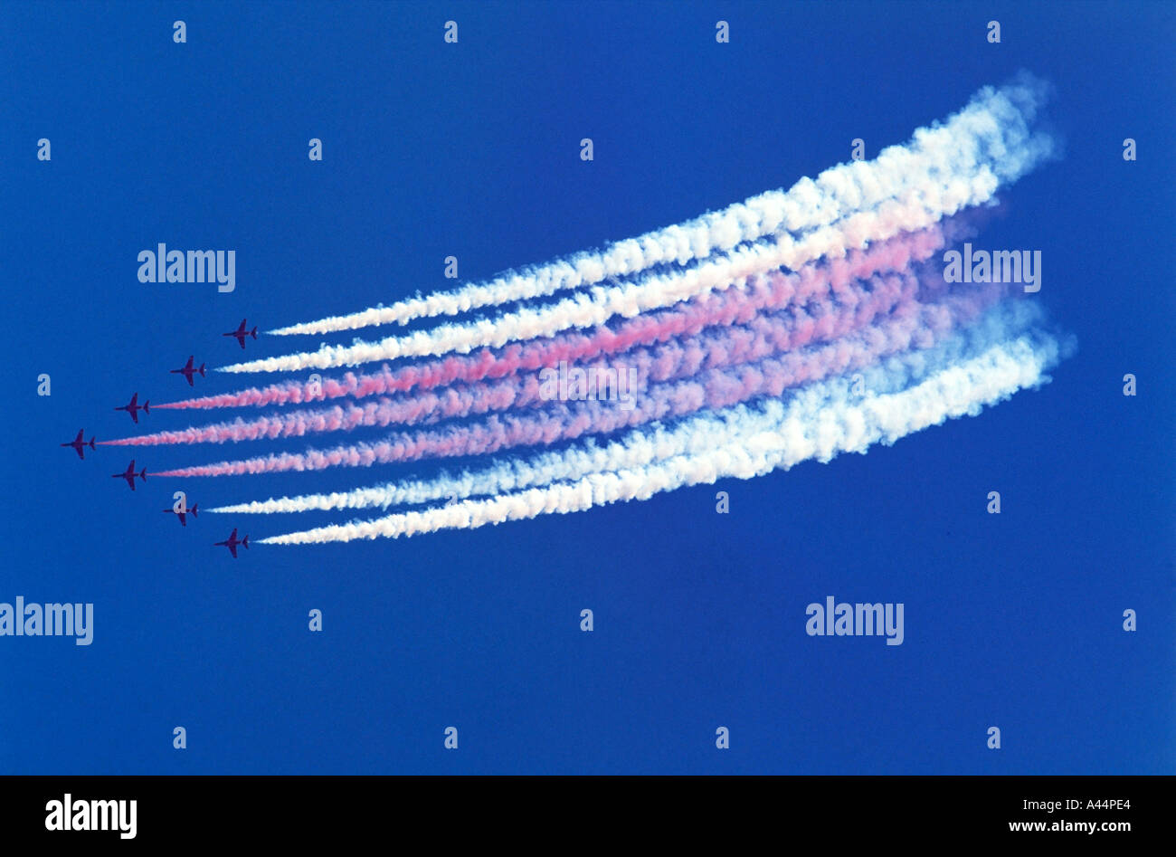 RAF Red Arrows display team in silhouette flying seven jets in a close ...