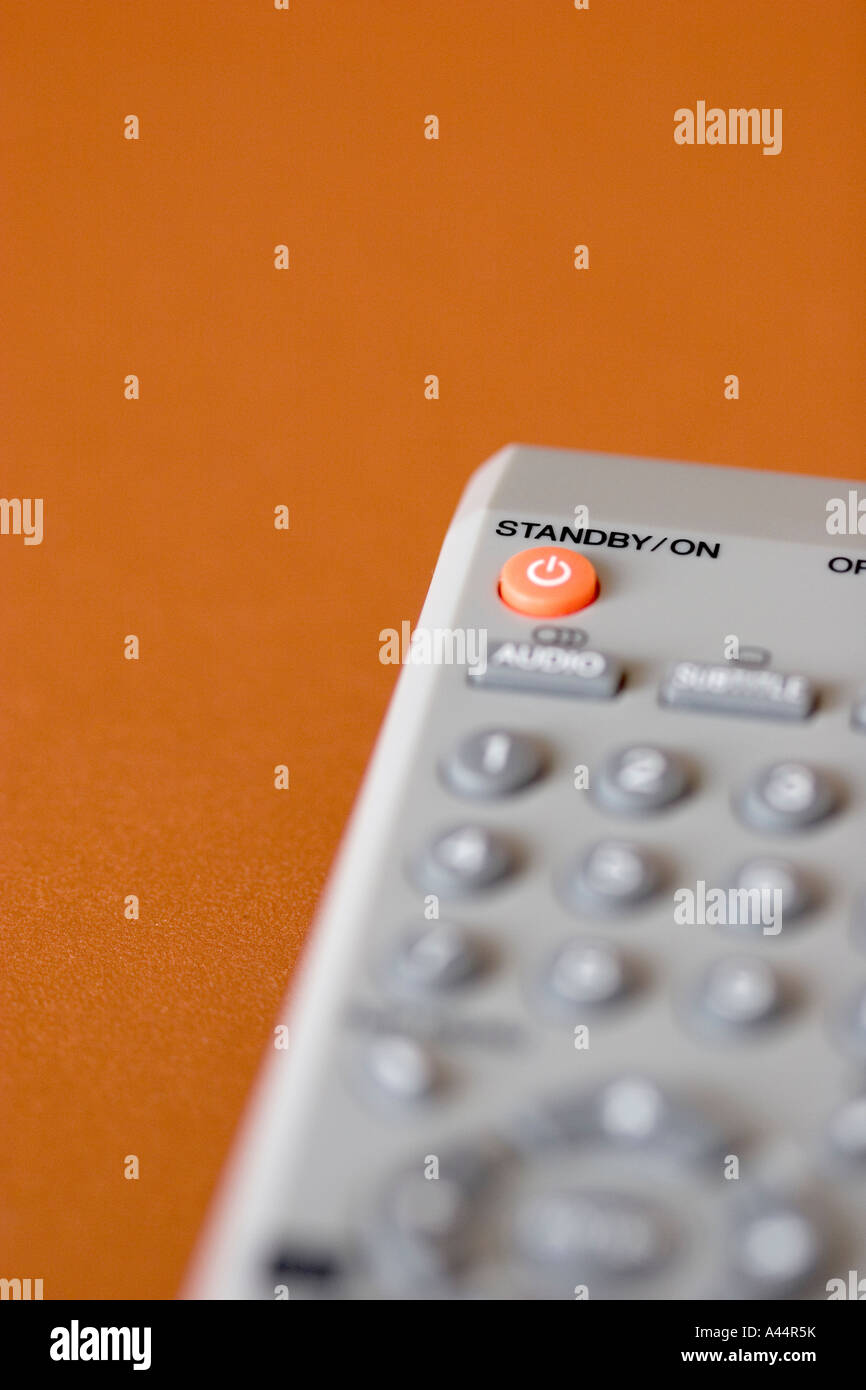 TV DVD stereo audio or home entertainment remote control on an orange ...