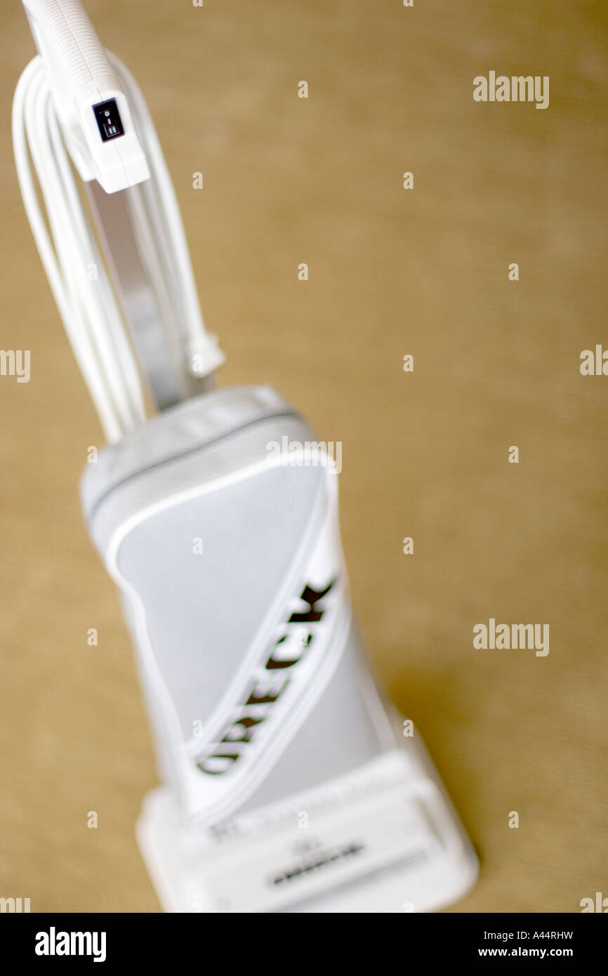 Household vacuum cleaner on a simple abstract gold or yellow background ...