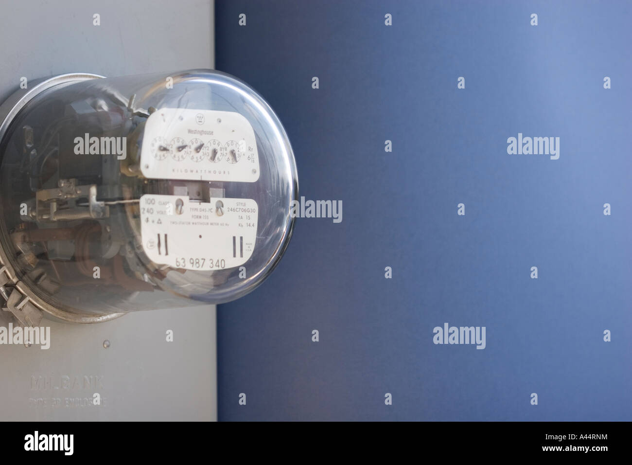 Mains supply electric power meter showing analog dials and glass cover ...