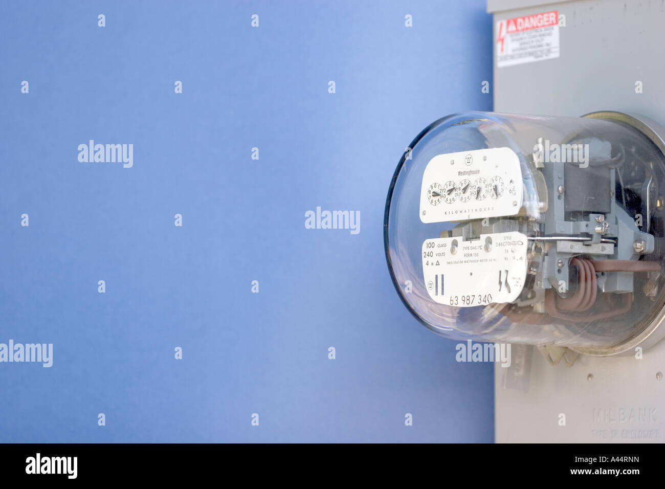 Mains supply electric power meter showing analog dials and glass cover ...