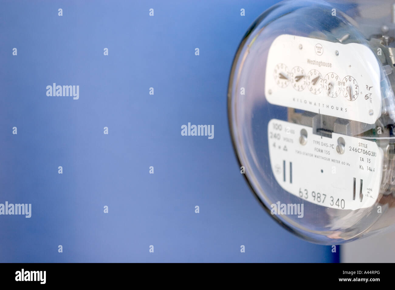 Mains supply electric power meter showing analog dials and glass cover ...