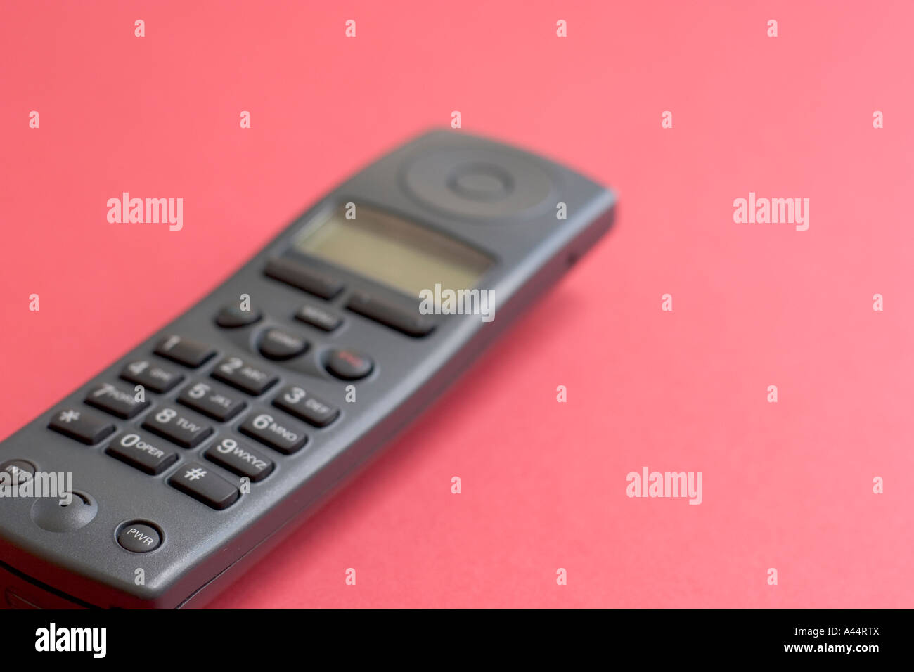 Sleek modern digital cordless phone on simple abstract red background ...