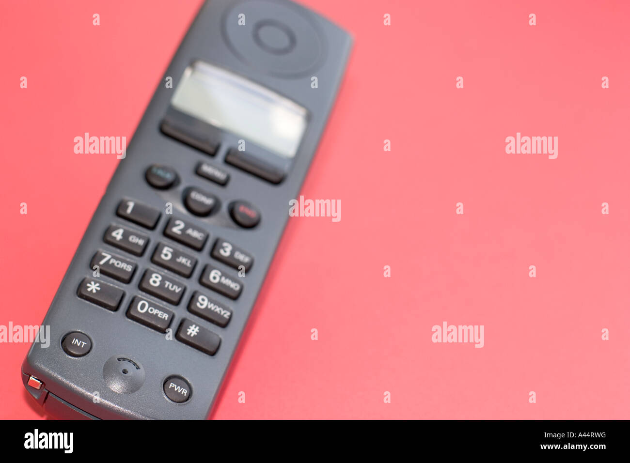 Sleek modern digital cordless phone on simple abstract red background ...