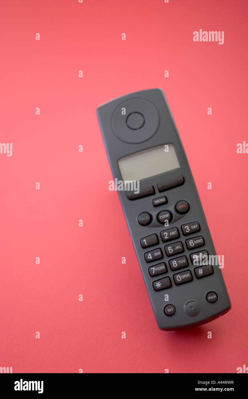 Sleek modern digital cordless phone on simple abstract red background ...