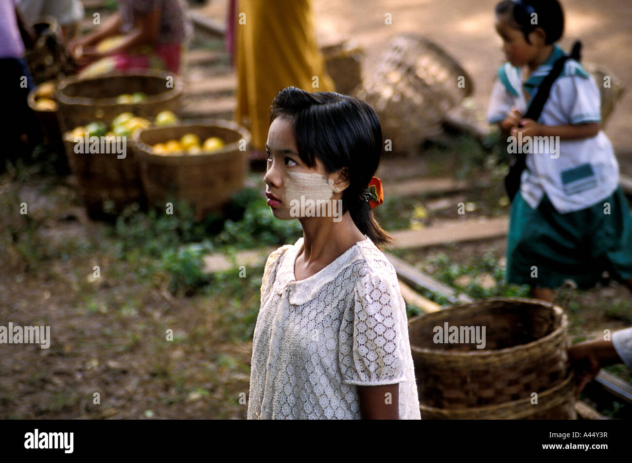 A Burmese girl wears a traditional makeup powder which is though to be ...