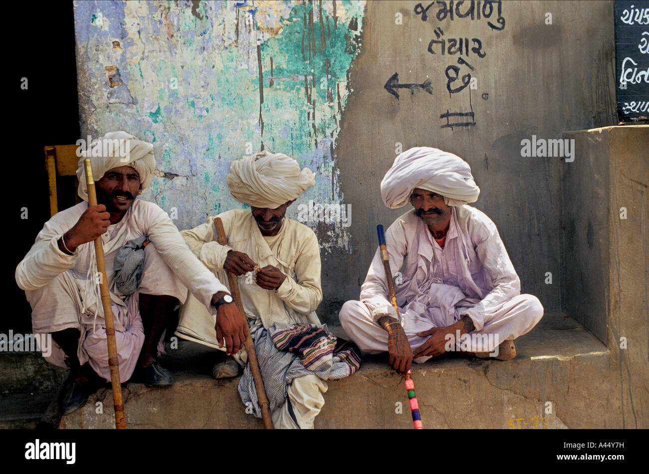 A group of Rabari men sit and relax during a hot afternoon in the ...
