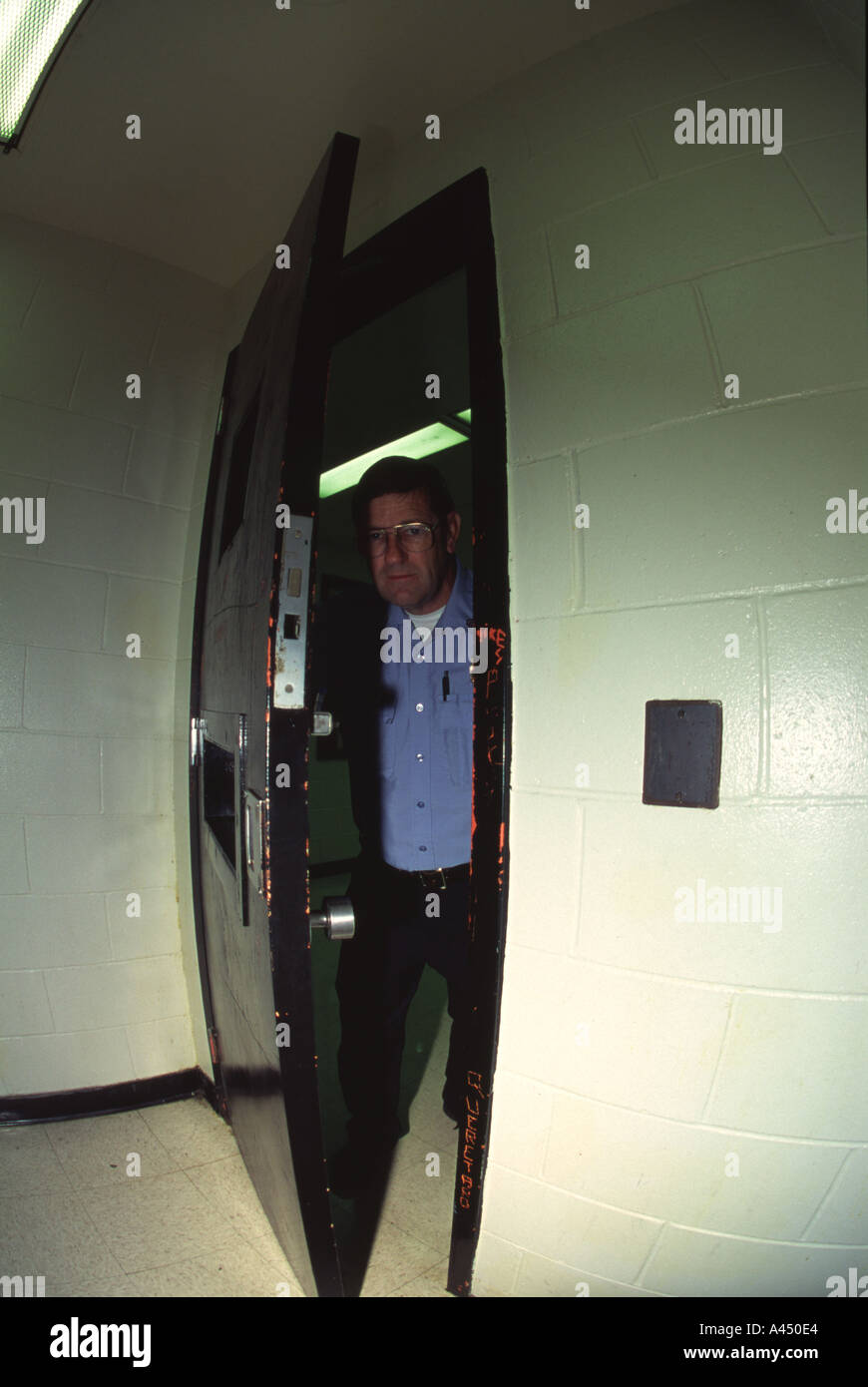 Prison interior Cell Corrections Officer looking in Stock Photo - Alamy