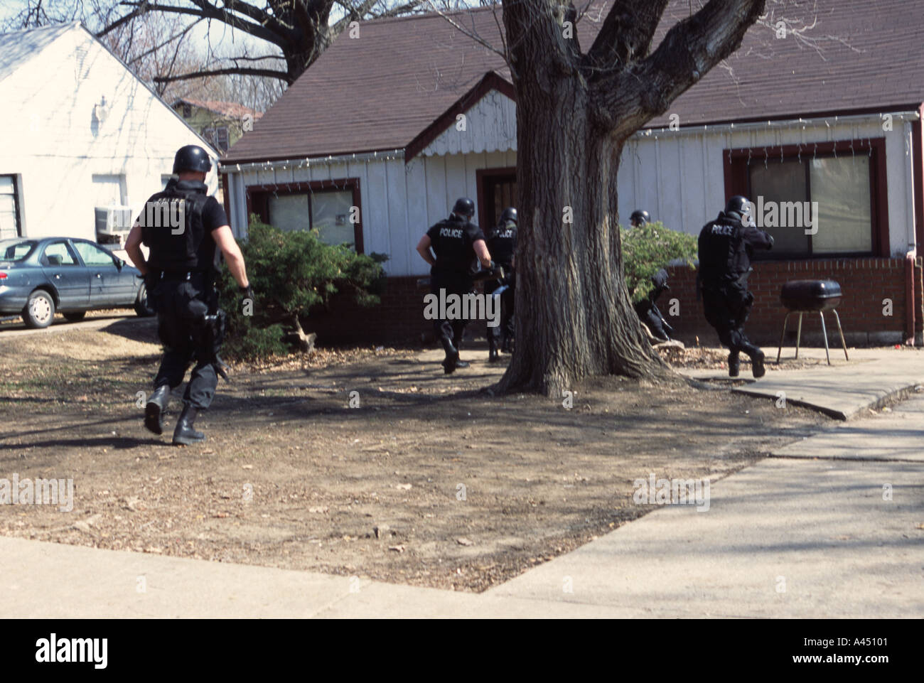 Police SWAT TAC team entering the house of a suspect to serve search ...