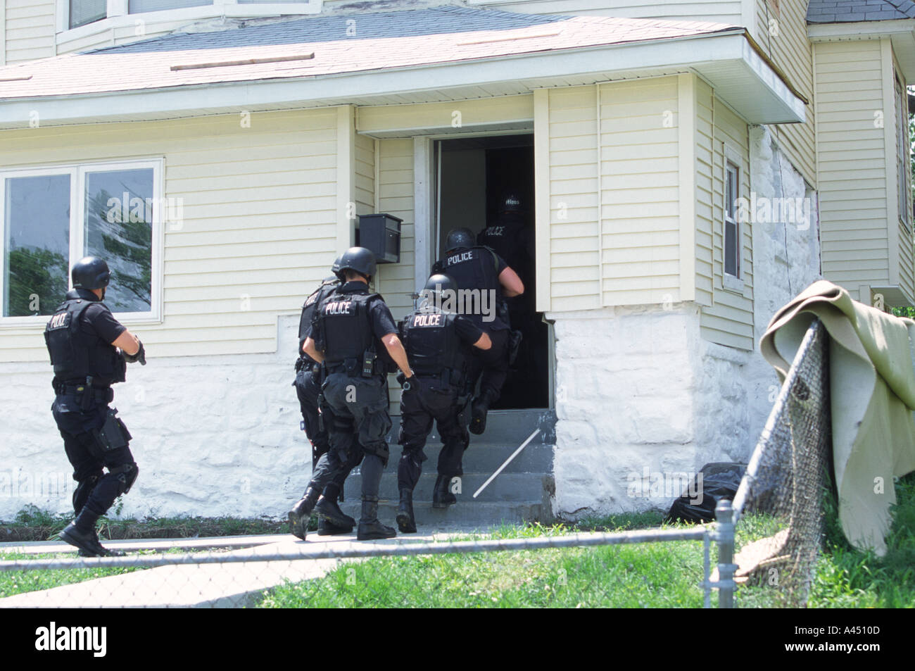 Police SWAT TAC Team entering suspects residence to serve search ...