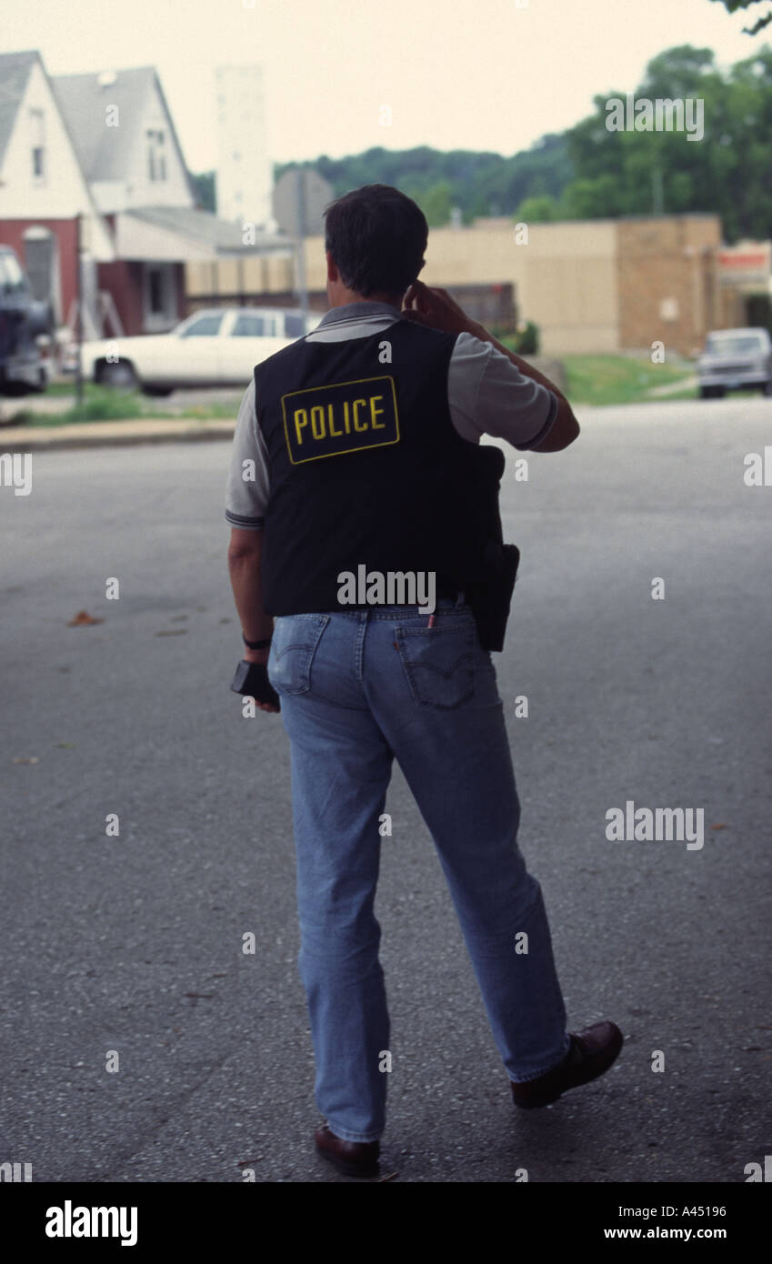 Plainclothes police sergeant using hand held radio. Kansas City, MO ...