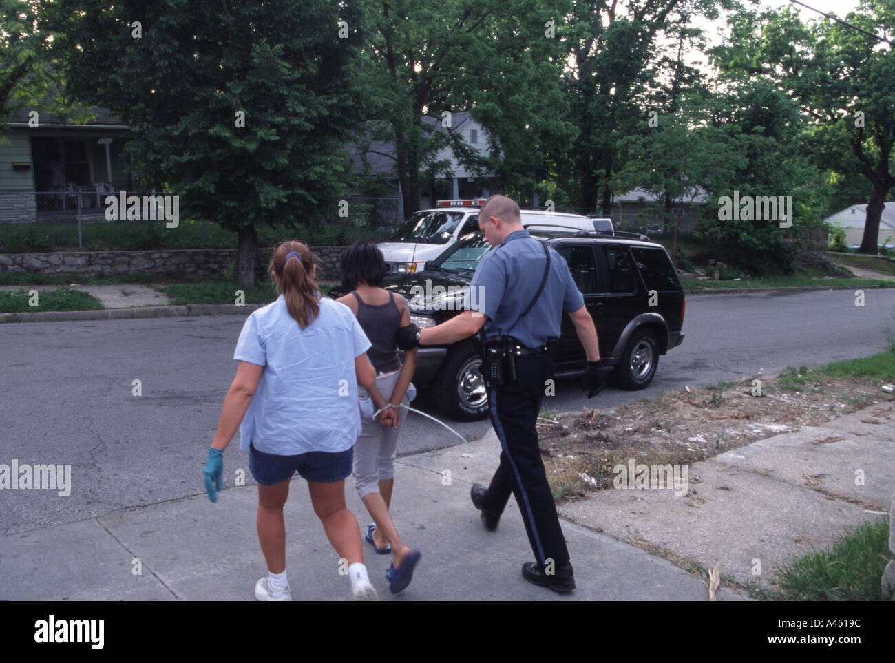 Police arresting female suspect Stock Photo - Alamy