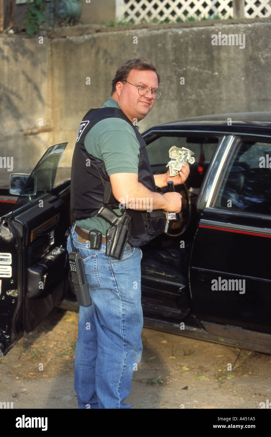 Police officer searching suspect s vehicle Stock Photo - Alamy