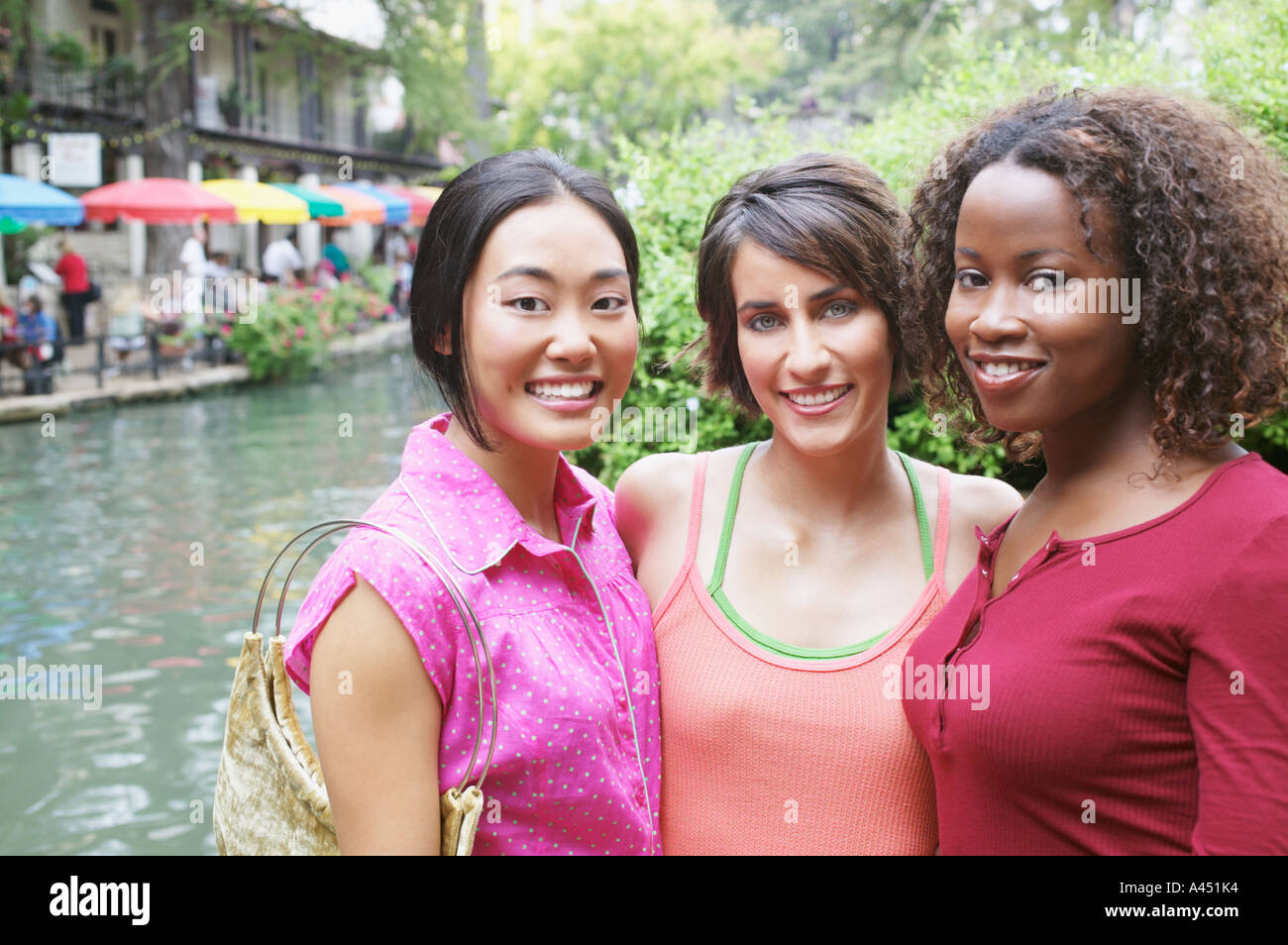 Three female friends standing outside Stock Photo - Alamy