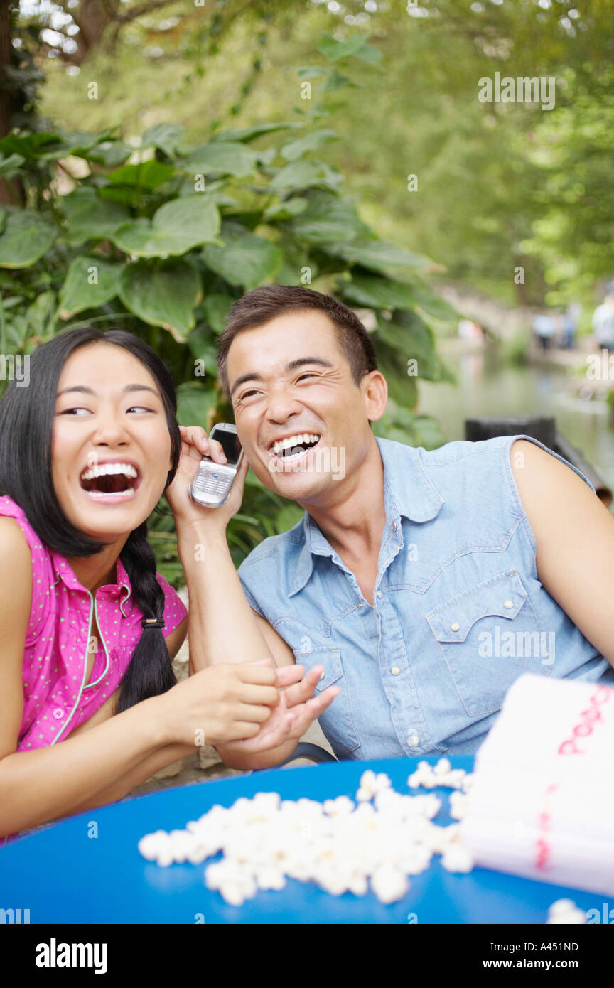 Young couple eating popcorn Stock Photo - Alamy