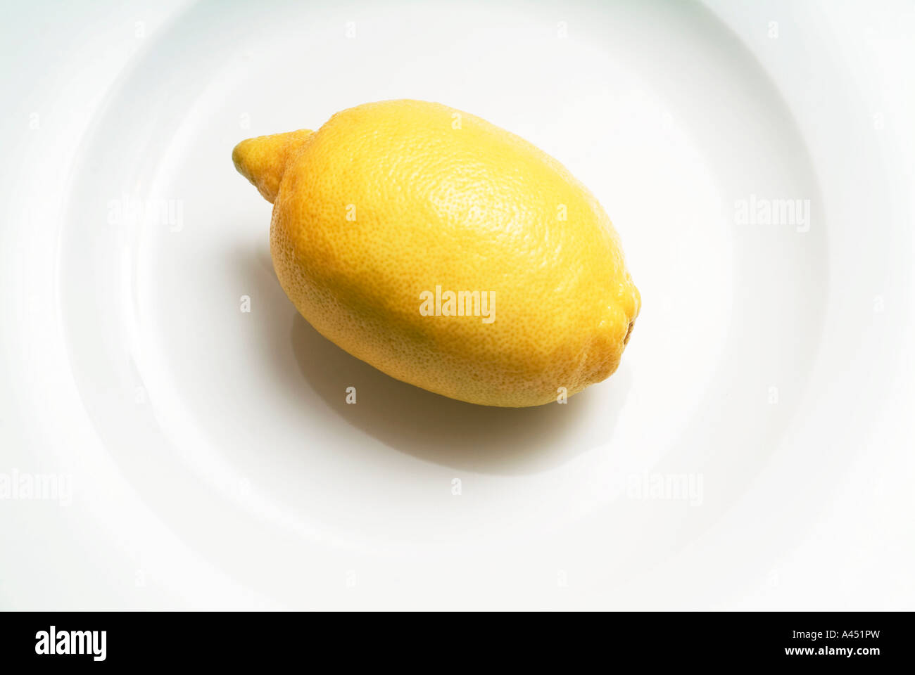 Lemon on plate Stock Photo - Alamy
