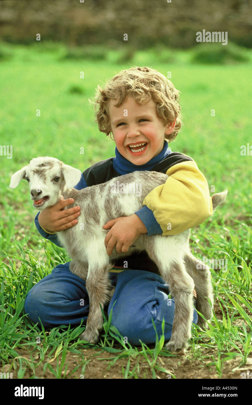Little goat and child Stock Photo - Alamy
