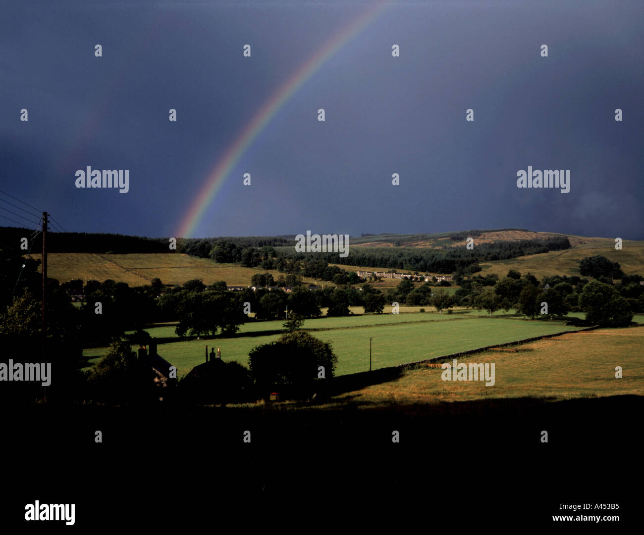 Rainbow over Falstone village in late afternoon, Northumberland ...