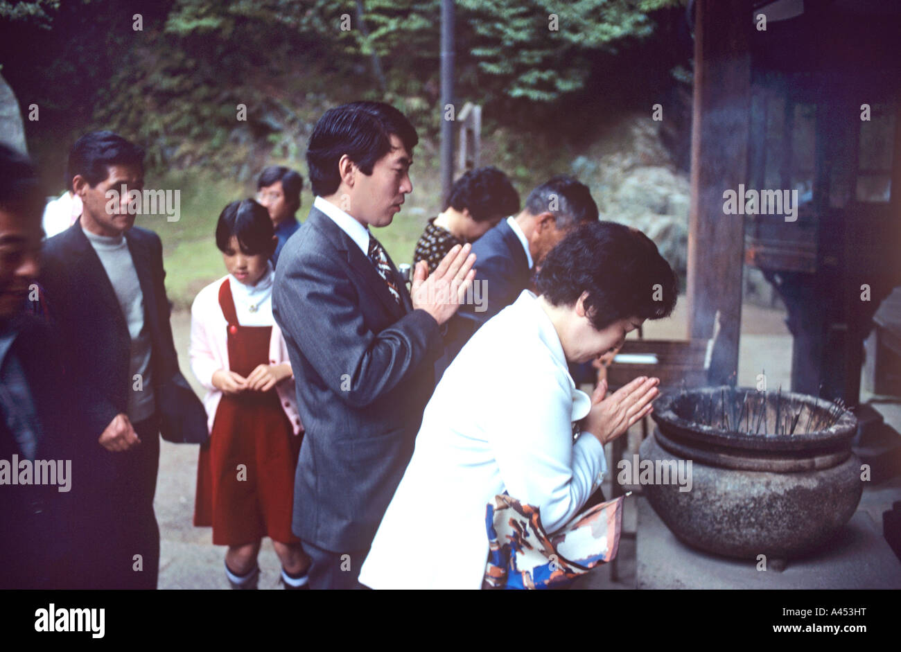 Japan, Kyoto prayer at Shinto shrine. They believe in syncretism, a ...