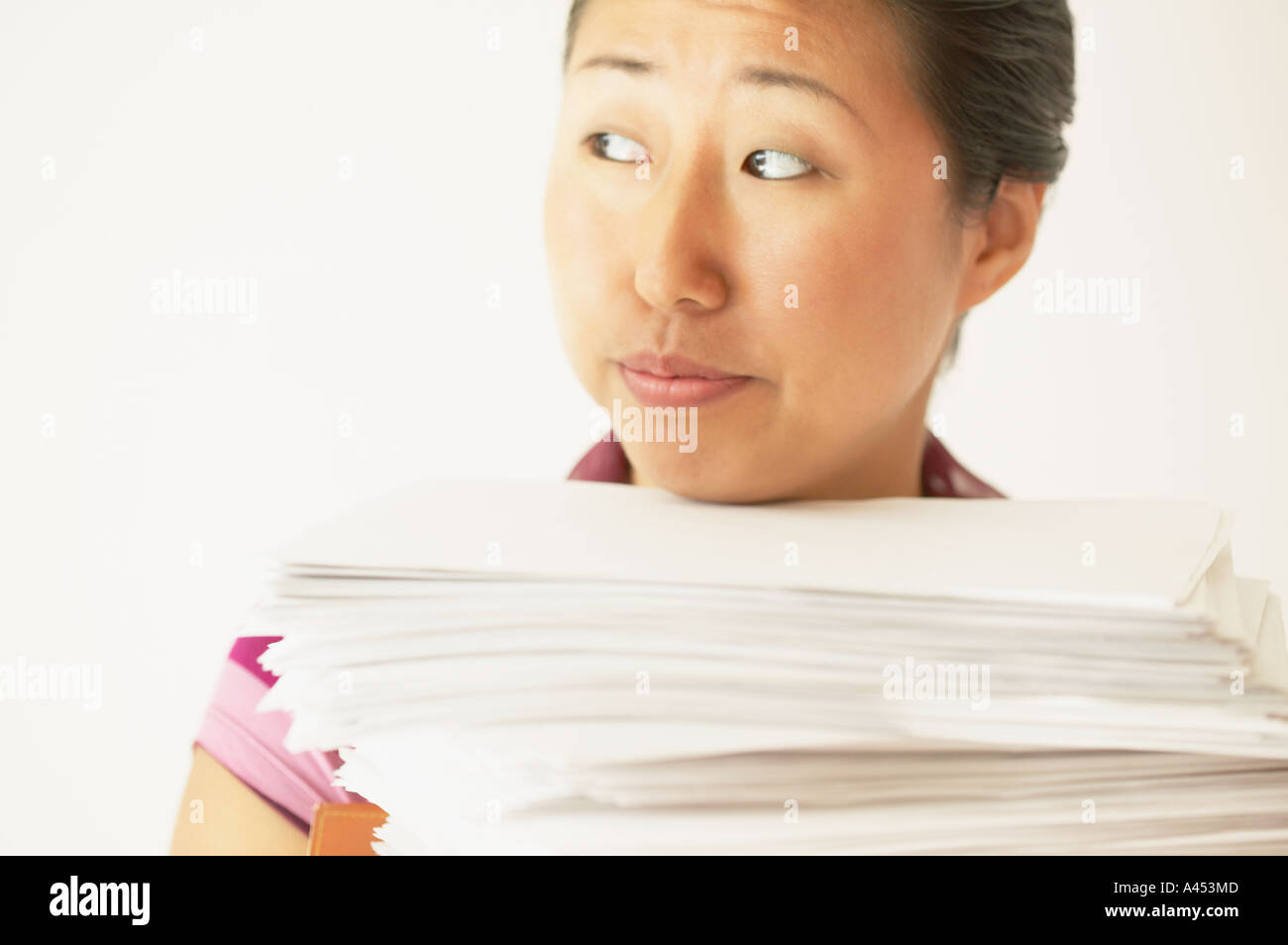 Young woman carrying a stack of papers Stock Photo - Alamy