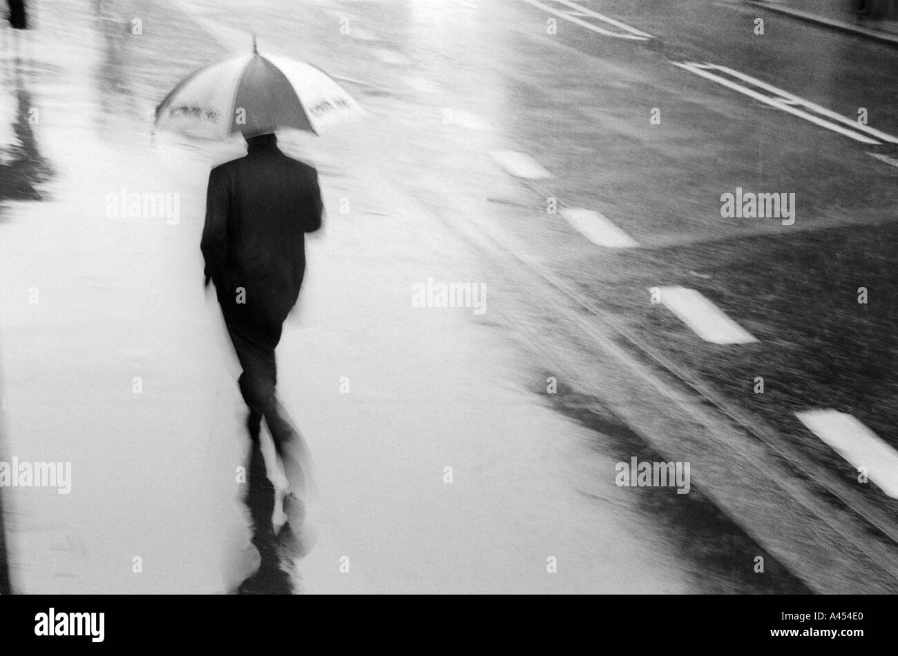 Man alone in rain with umbrella Black and White Stock Photos & Images ...