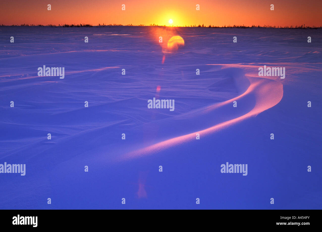 Sun setting over the eternal snow of the Tundra landscape in Wapusk NP ...