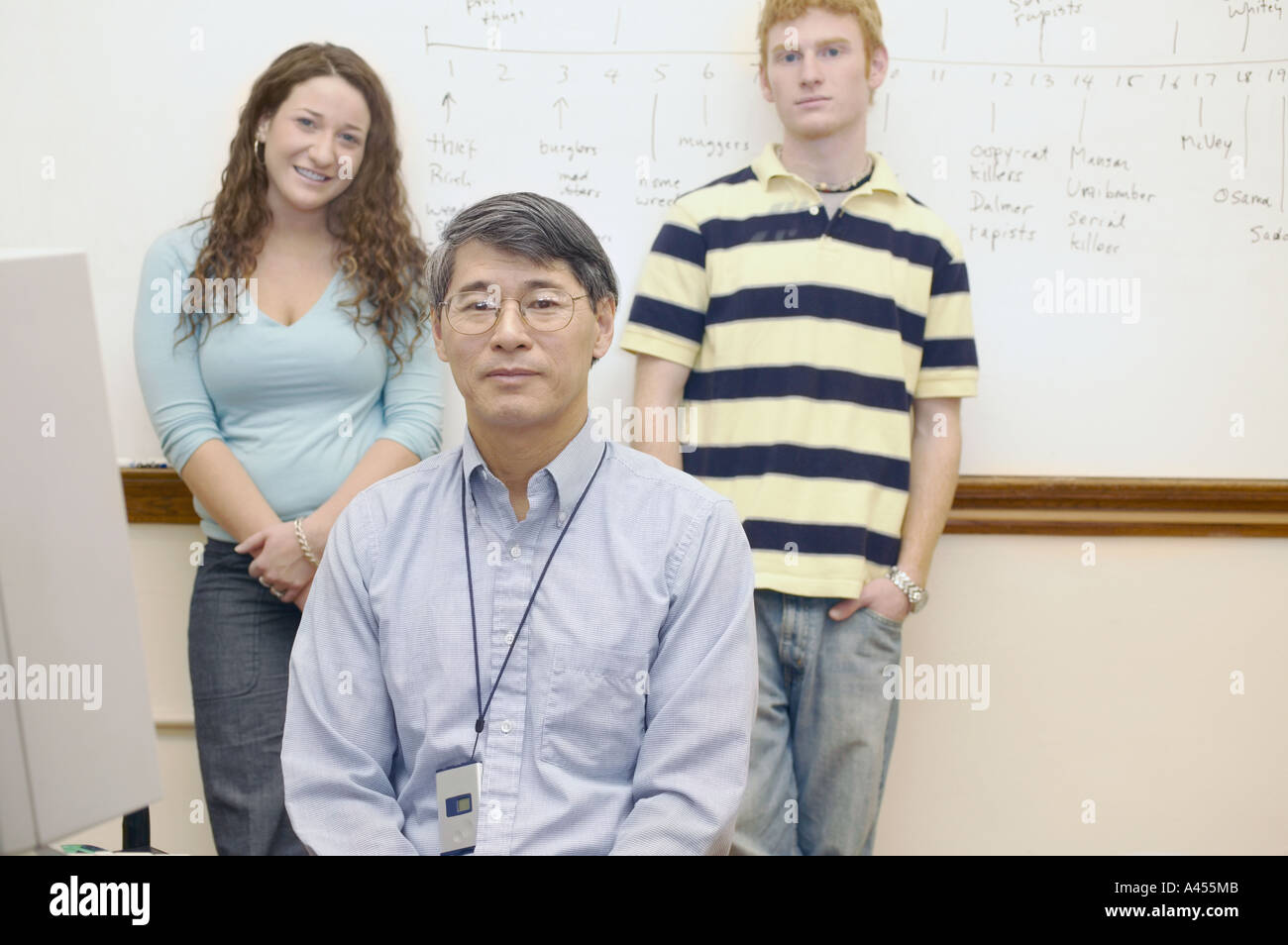 Male teacher with two students Stock Photo - Alamy