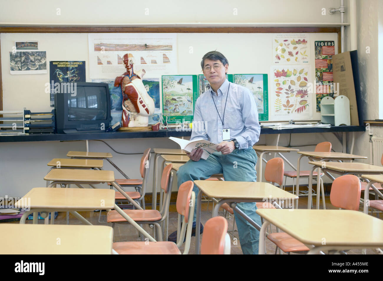 Male teacher in classroom Stock Photo - Alamy