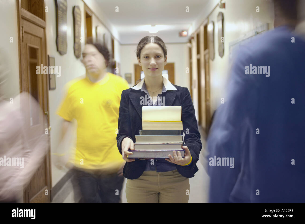 Teenage girl carrying books Stock Photo - Alamy