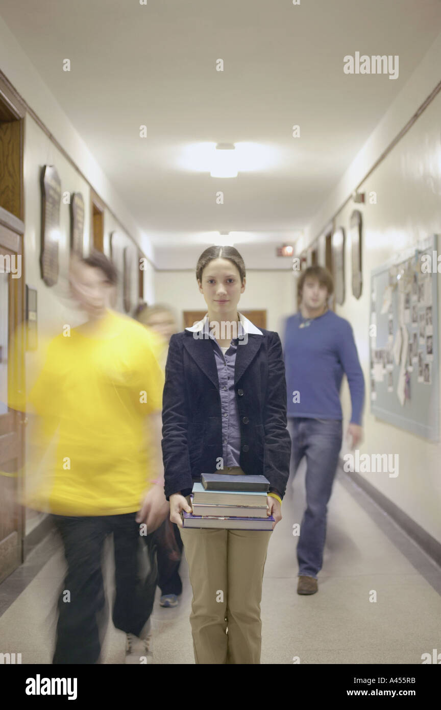 Teenage girl carrying books Stock Photo - Alamy