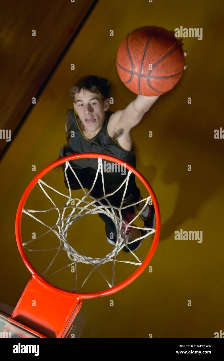 Basketball player about to slam dunk the ball Stock Photo - Alamy
